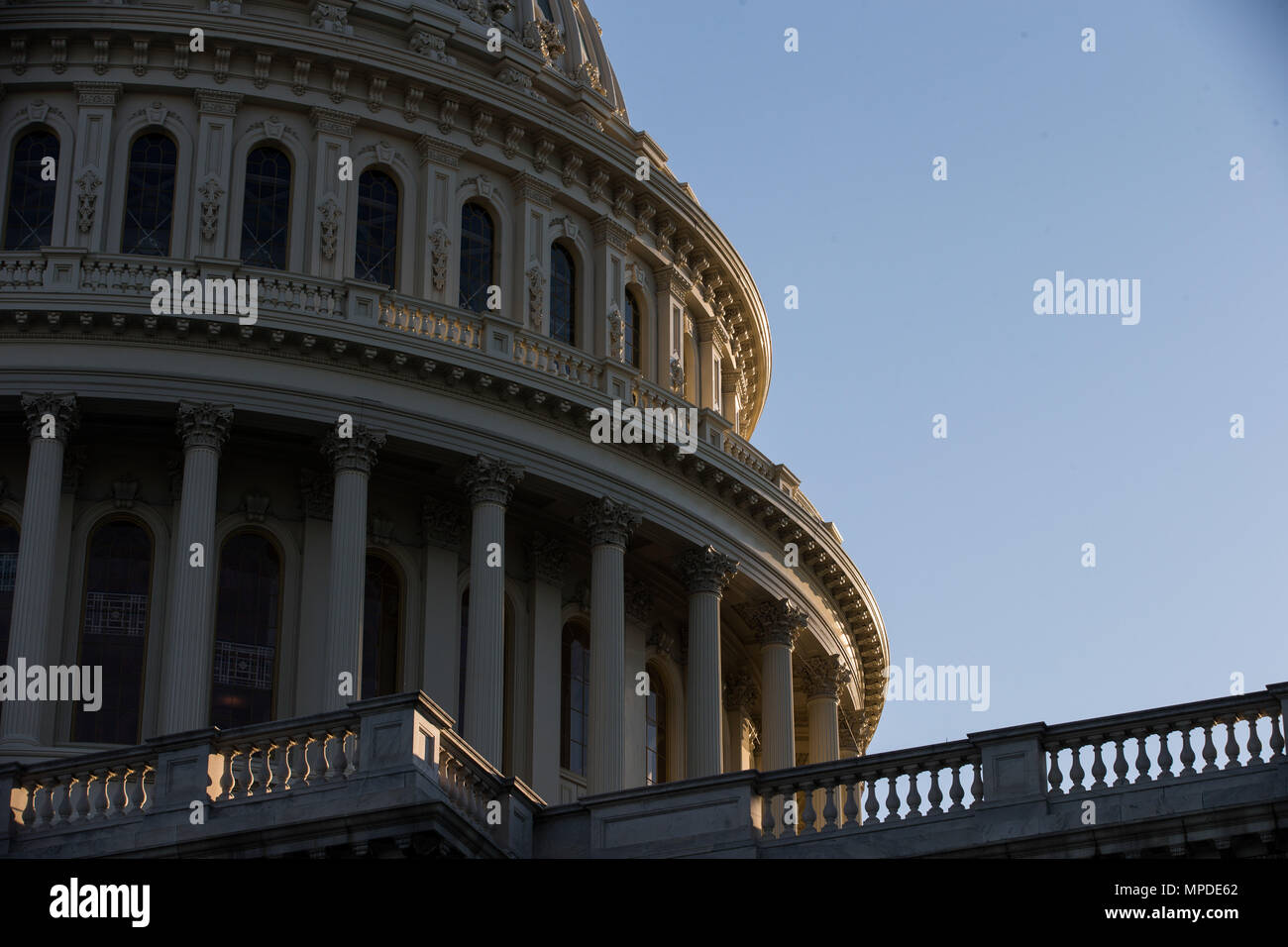 Sunlight illuminates the west face of the the U.S. Capitol prior to ...