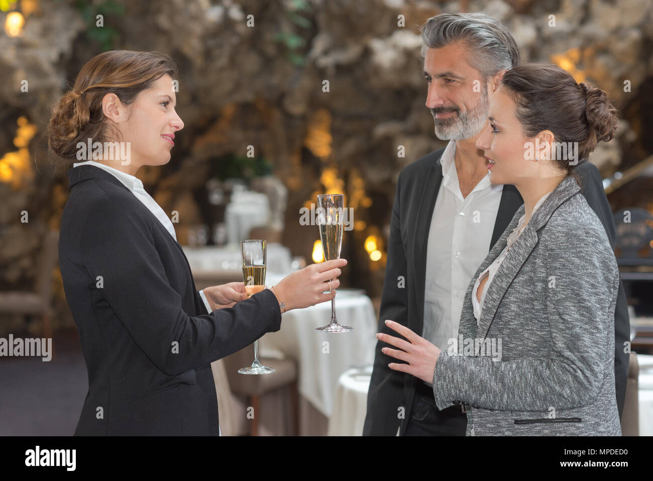 Couple serve by waiter hi-res stock photography and images - Alamy