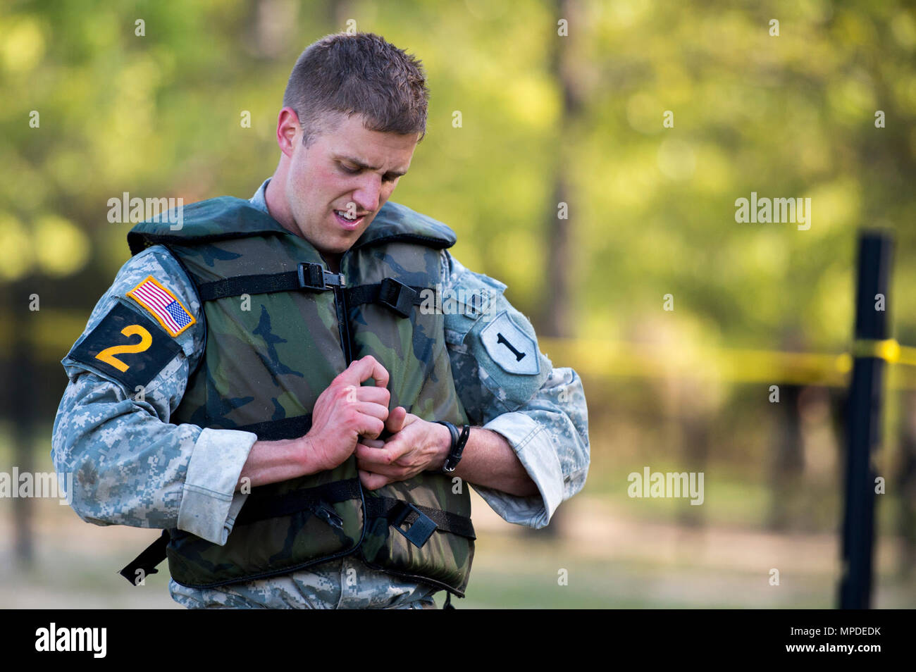 A U.S. Army Ranger prepares to jump into Victory Pond out of a UH-60 ...