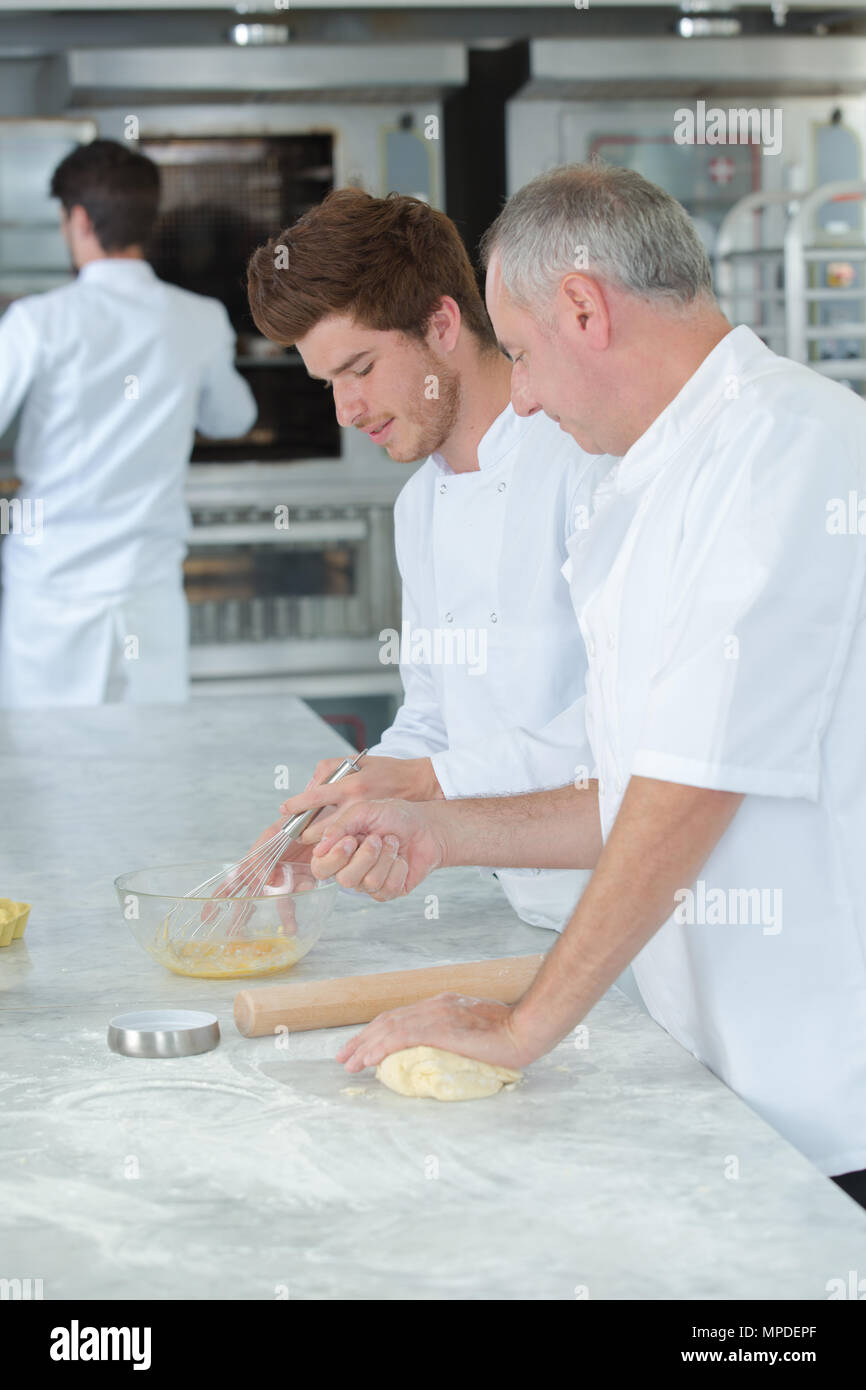 chef giving lesson to the intern Stock Photo - Alamy