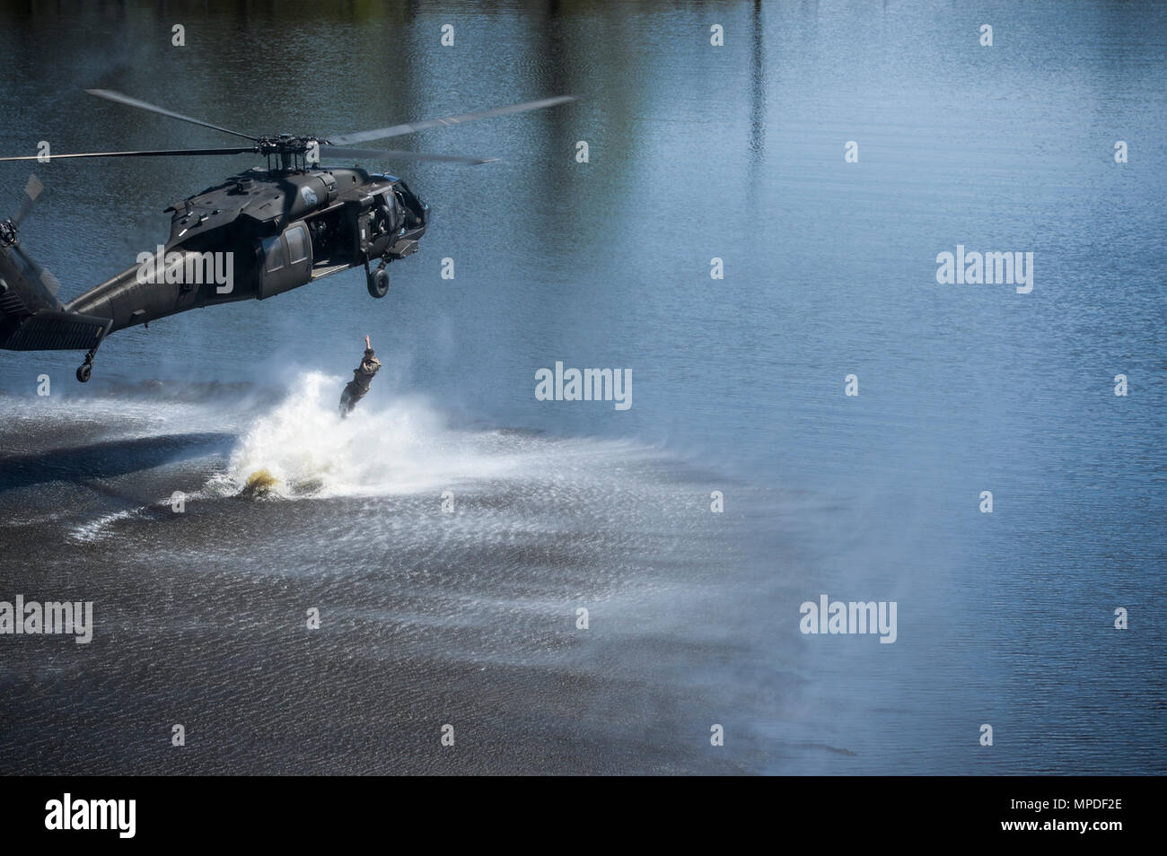 U.S. Army Ranger jumps out of a UH-60 Black Hawk helicopter into ...