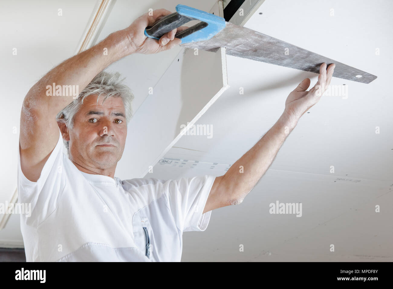 Mason sawing at an awkward angle Stock Photo - Alamy