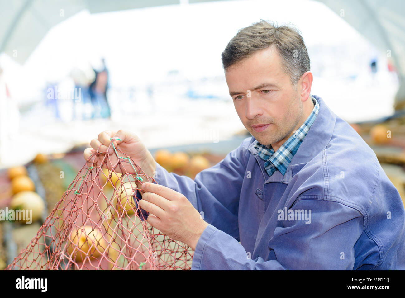 Man holding net nets hi-res stock photography and images - Alamy