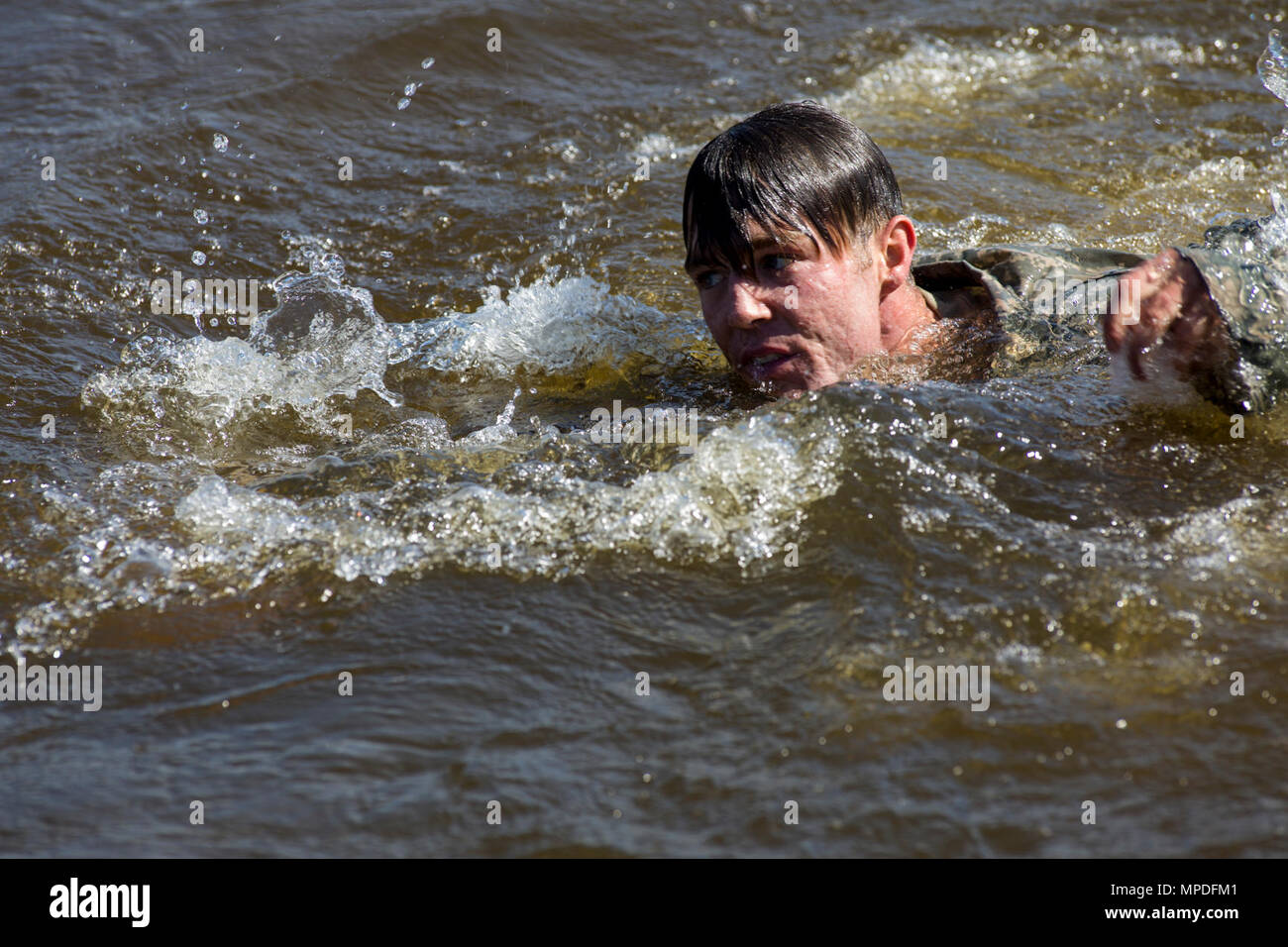 A U.S. Army Ranger swims ashore to perform the Combat Water Survival ...