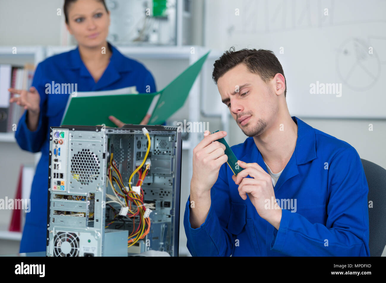 team of students examining and repairing computer parts Stock Photo - Alamy