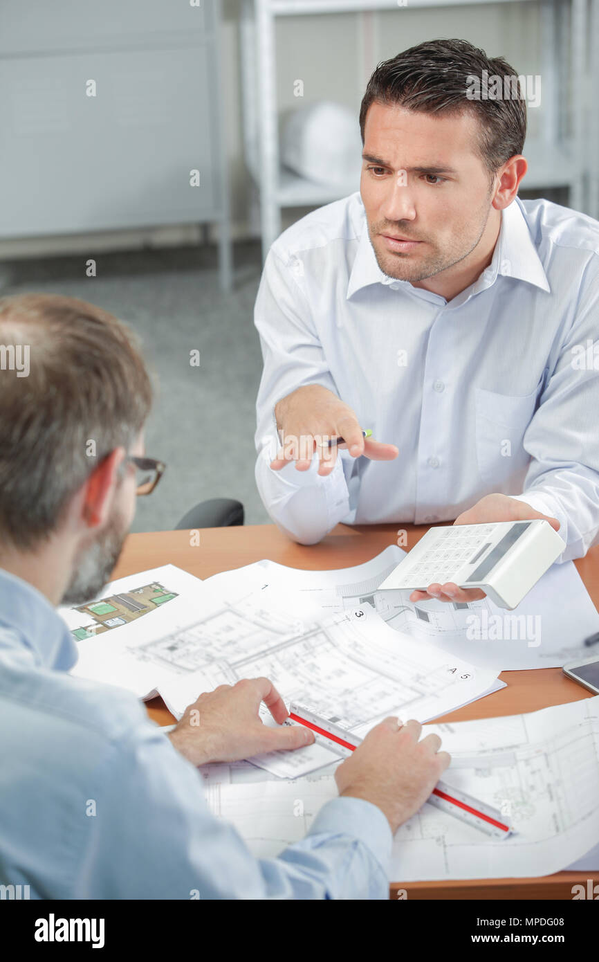 Architect crunching some numbers Stock Photo - Alamy