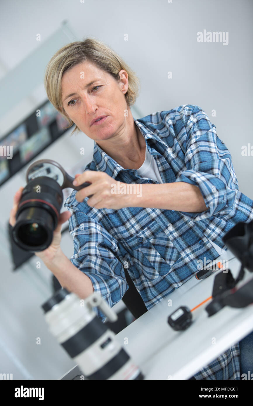 female photographer checking lens Stock Photo - Alamy