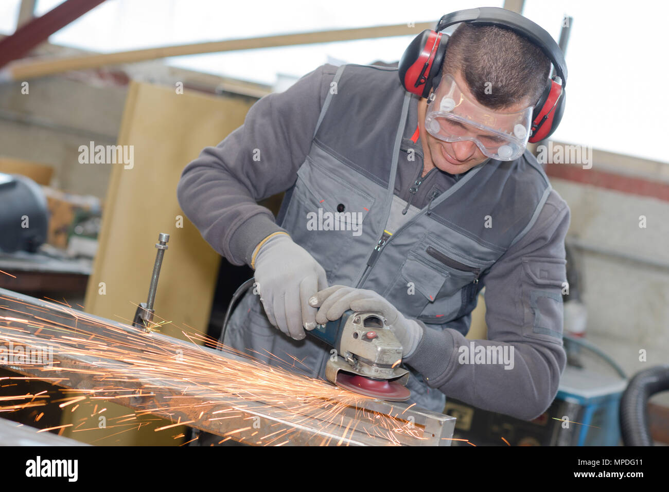 Worker using grinder hi-res stock photography and images - Alamy