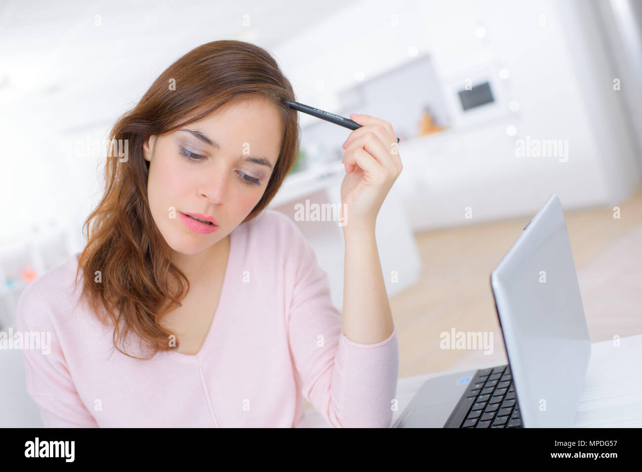 female journalist using laptop and thinking Stock Photo - Alamy