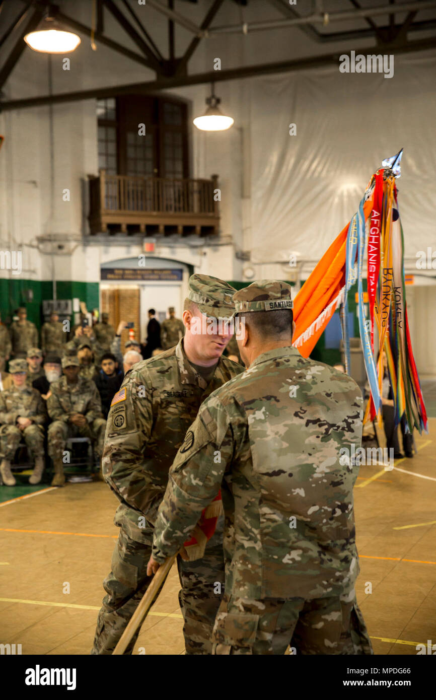 U.S. Army Maj. Ian Seagriff passes the battalion colors to the ...