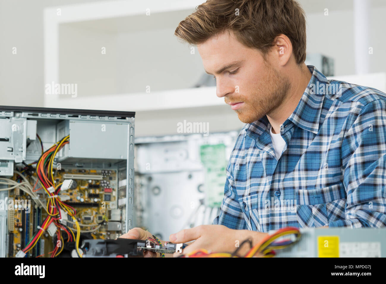 handsome computer engineer repairing a faulty pc Stock Photo - Alamy