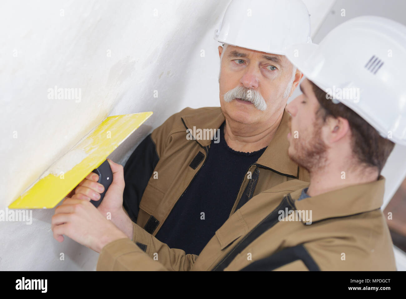 men plastering a brick wall restoration Stock Photo - Alamy