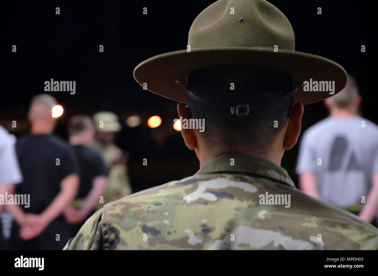 A Drill Sergeant from the 98th Training Division (IET) looks on as ...