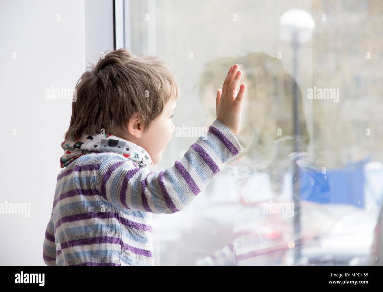Handsome boy smiling to someone in window Stock Photo - Alamy