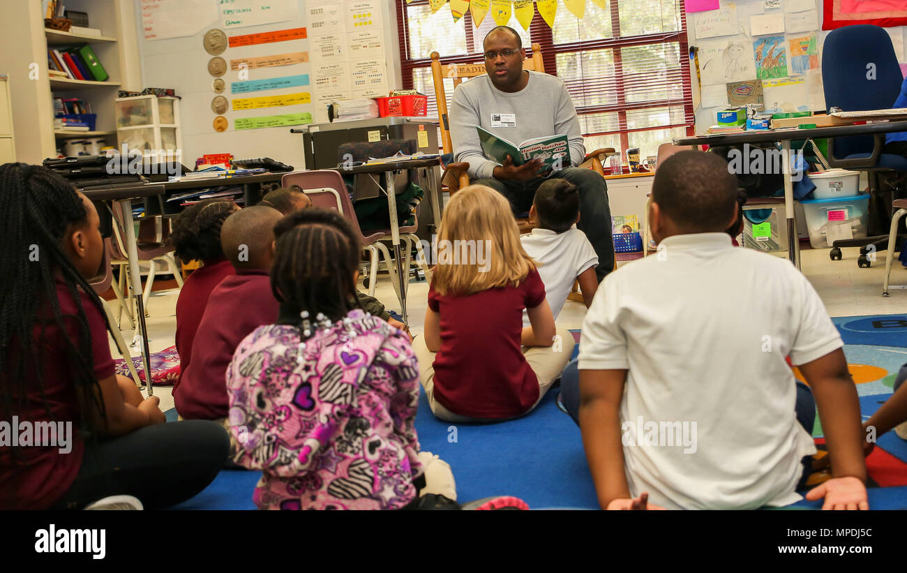 Petty Officer Second Class Ray Norfleet reads to a class at Joseph S ...