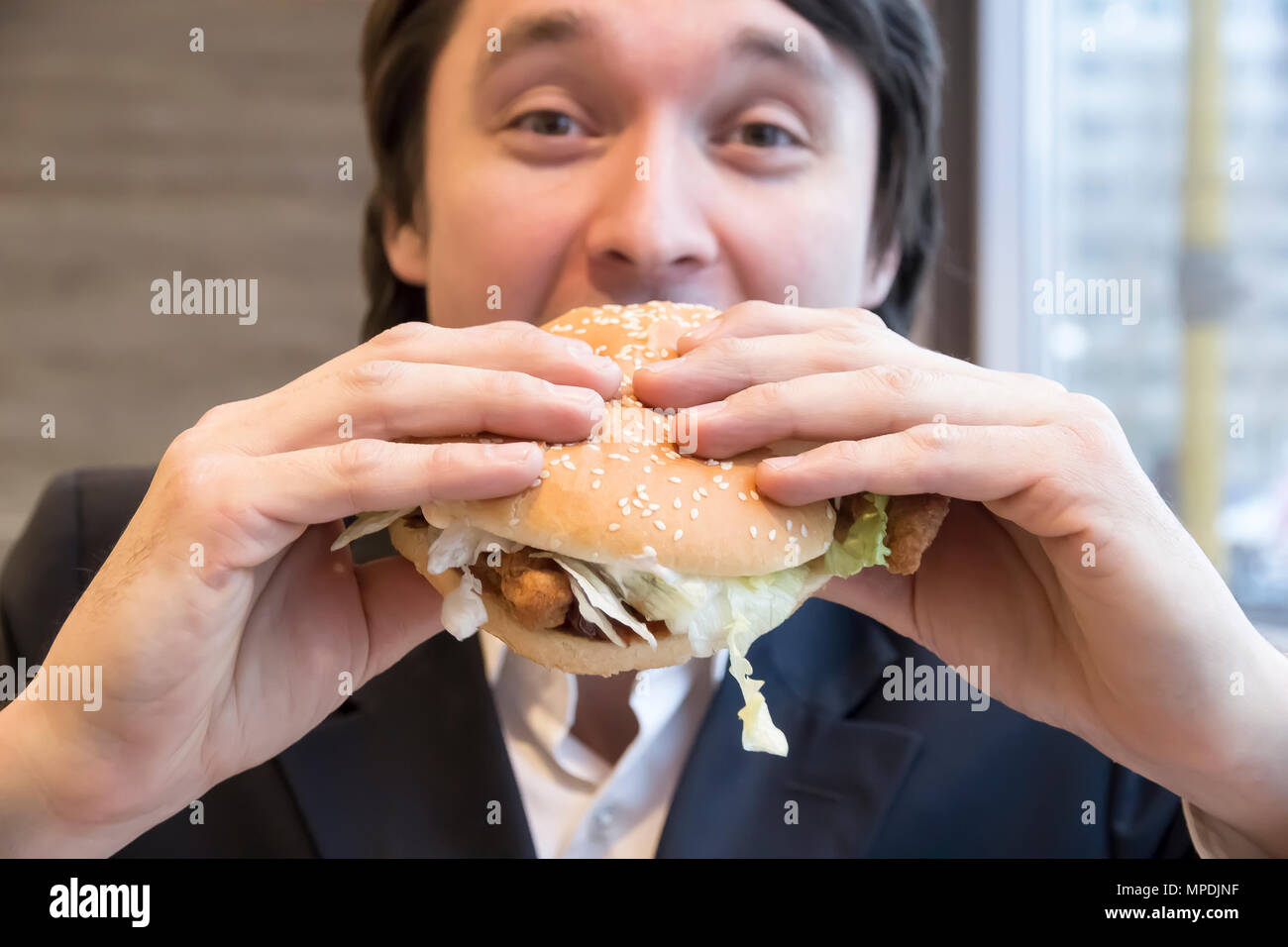 Business man eating hamburger hi-res stock photography and images - Alamy
