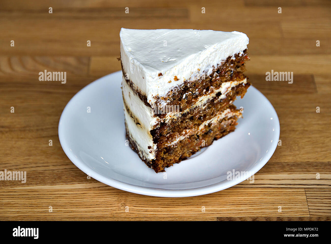 Serve walnut layer cake with cream on saucer in cafe Stock Photo - Alamy