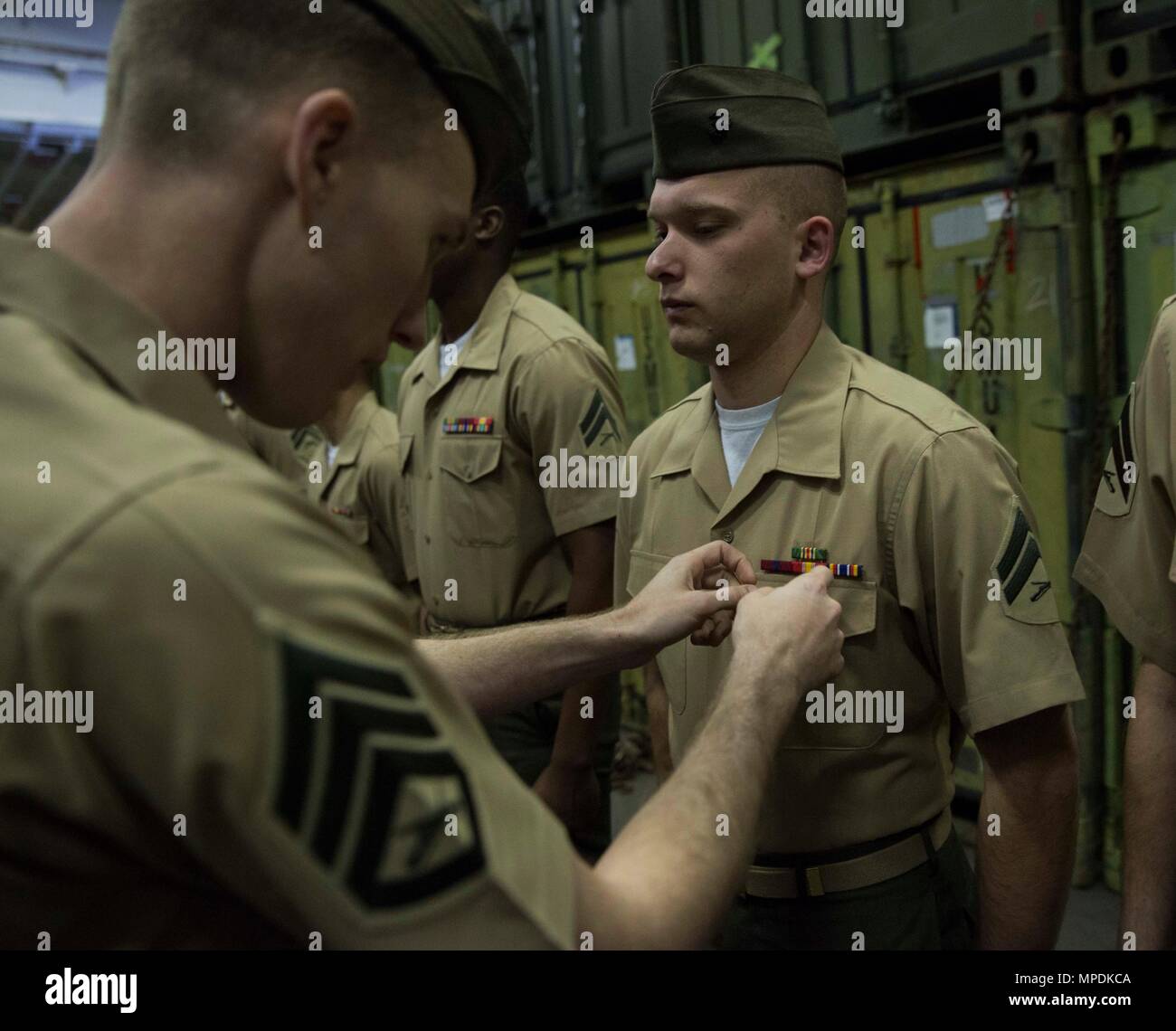 Marines with 3rd Battalion 6th Marine Regiment hold a service uniform ...