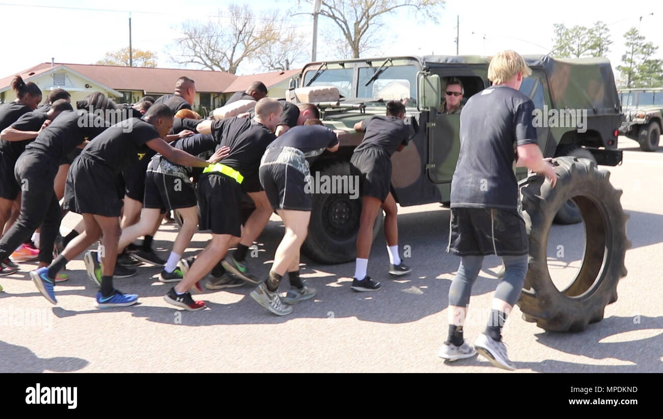Soldiers push a humvee up a hill in the last event at the Spartan ...