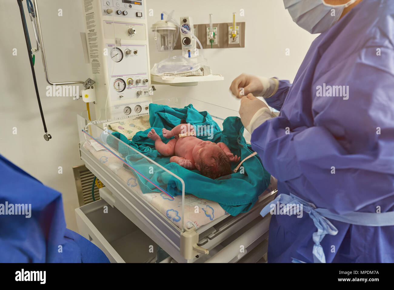 Checking health of newborn baby in hospital background Stock Photo - Alamy