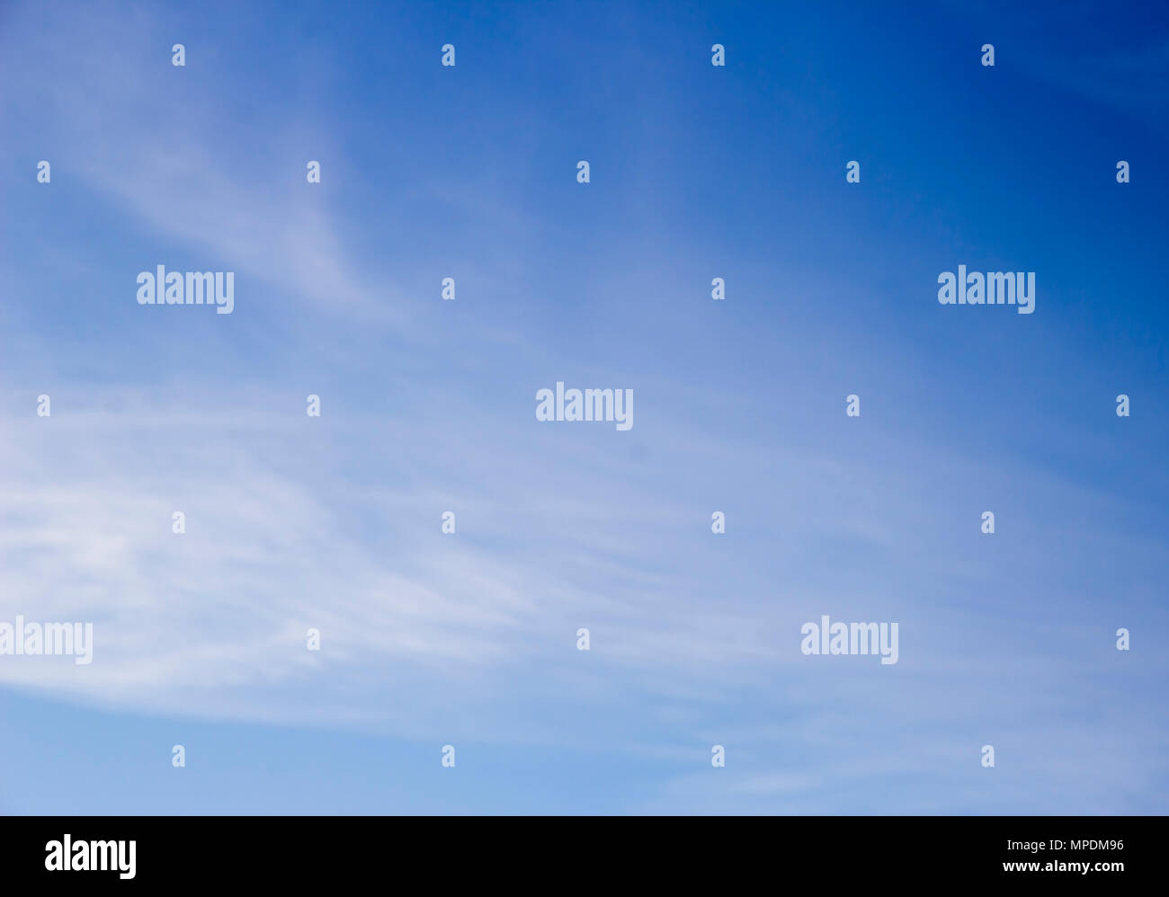 Clear blue sky with rare blurry white clouds Stock Photo - Alamy