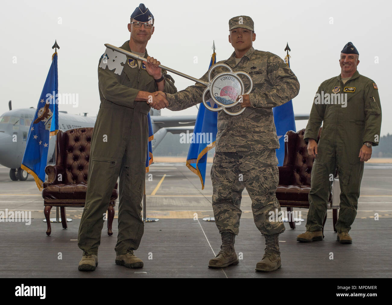 Maj. Gen. Mark Dillon, Pacific Air Forces vice commander, hands a ...