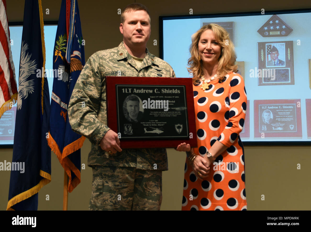 The family of 1st Lt. Andrew Shields holds the plaque dedicated to the ...