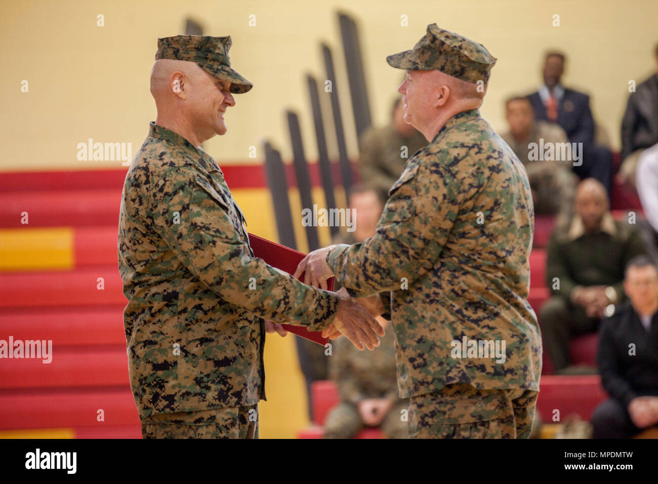 U.S. Marine Corps Sgt. Maj. Robert W. Pullen, left, is presented with ...