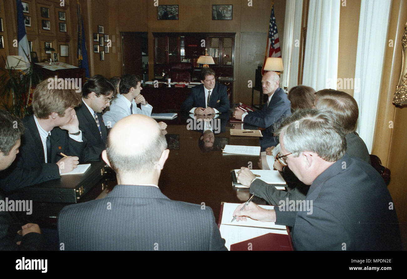 men and woman sitting at conference table Stock Photo - Alamy