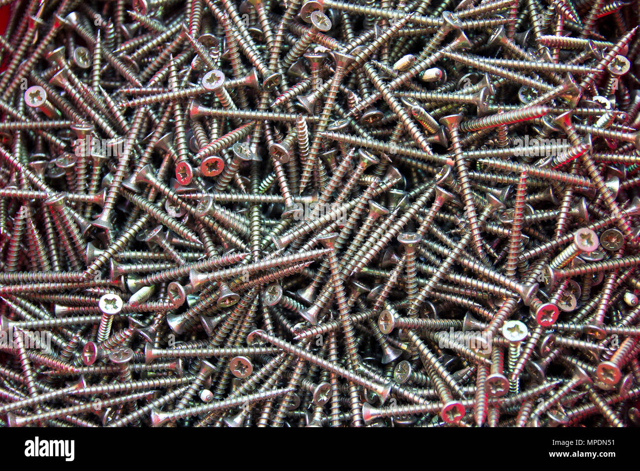 lot of short metal screws macro Stock Photo - Alamy
