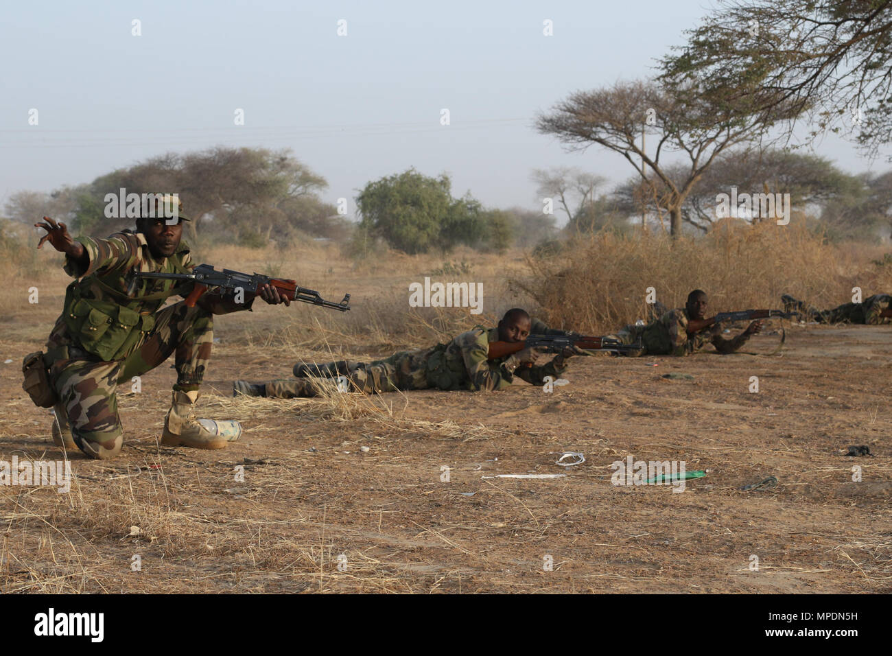 A Niger Army patrol leader signals to his soldiers during small unit ...