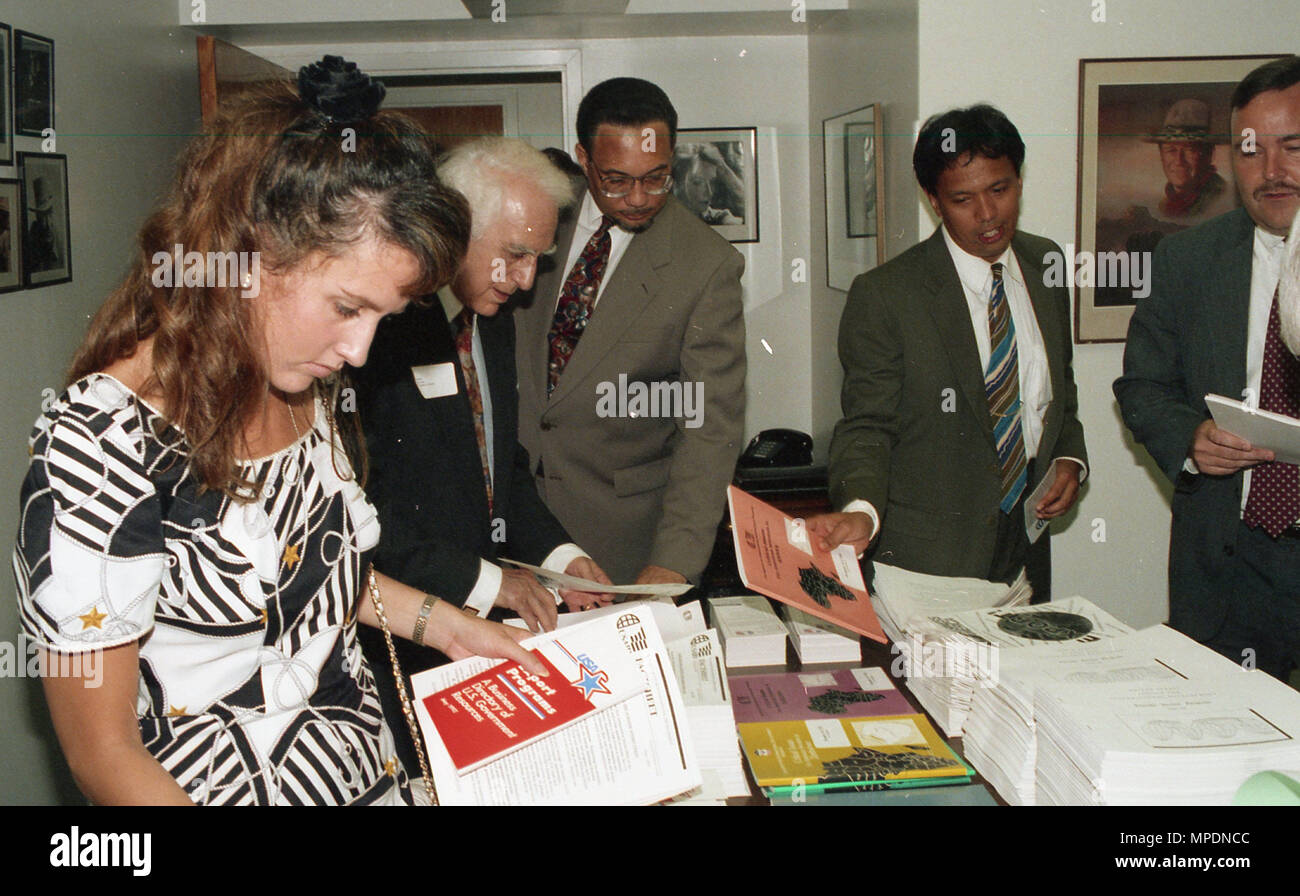 people looking through books Stock Photo - Alamy