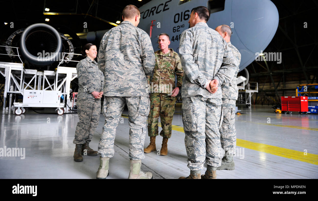 U.S. Army Maj. Gen. Gary Volesky (center), listens during a 62nd Maintenance Squadron operations ...