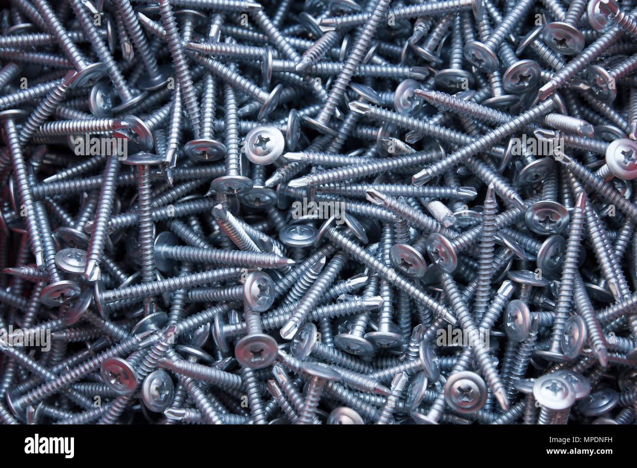 lot of short metal screws macro Stock Photo - Alamy
