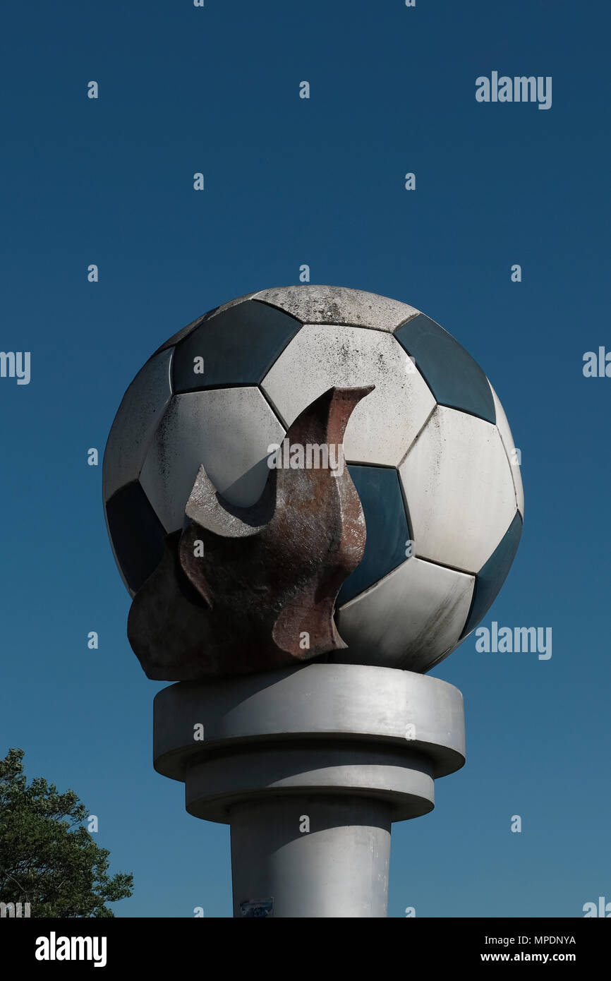 A Soviet-era sculpture of a football in front of the Communist-era ...