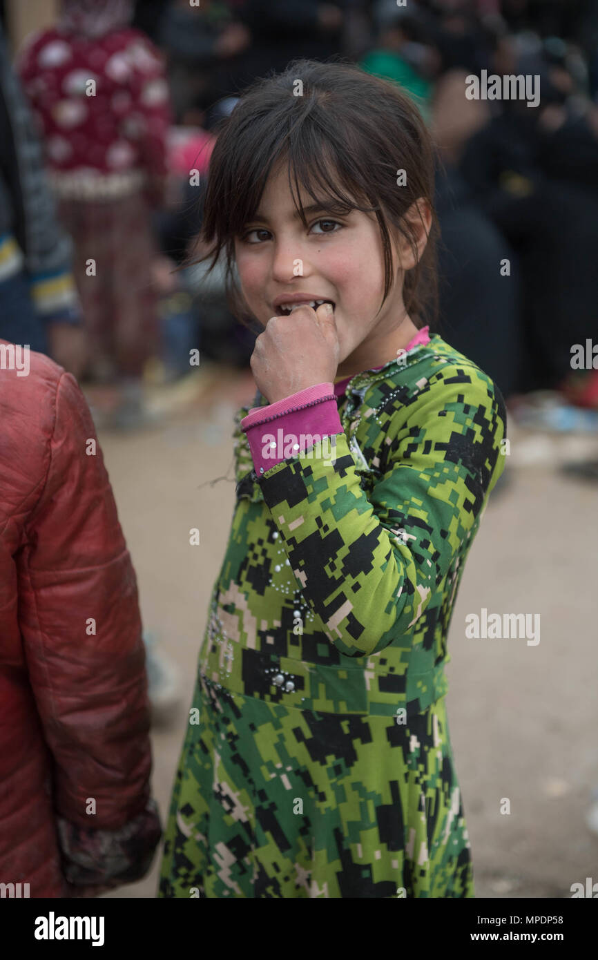 Internally displaced child waits at a processing station for internally ...