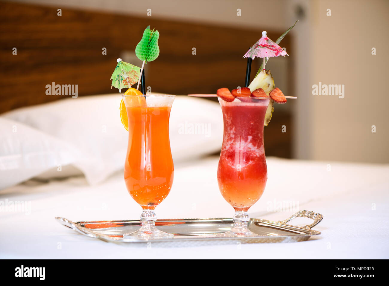 Two drinks on bed room hotel Stock Photo - Alamy