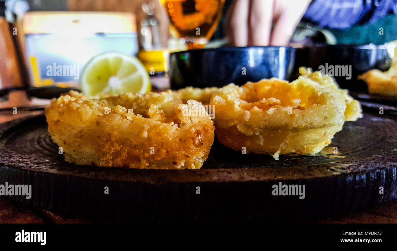 Fried Squid with lemon at the restaurant. seafood concept Stock Photo ...