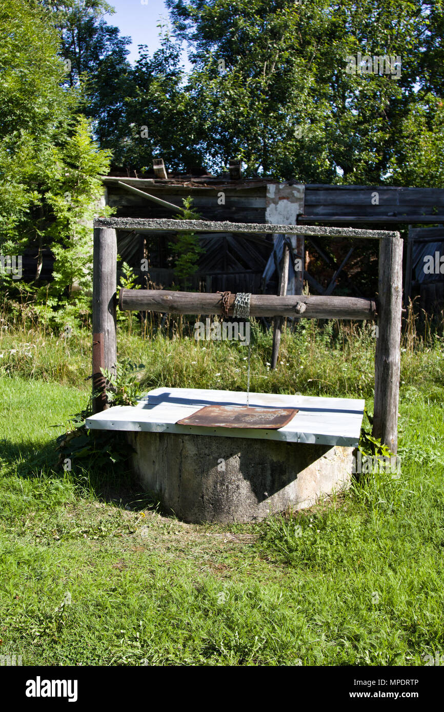 community well in Russian village in background of garden and poor ...