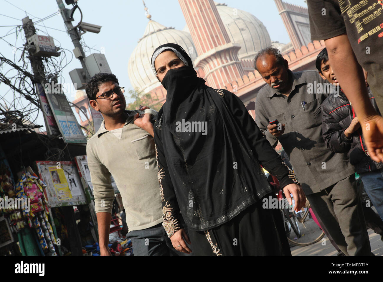 India, New Delhi, A muslim woman walks through the streets of the old ...
