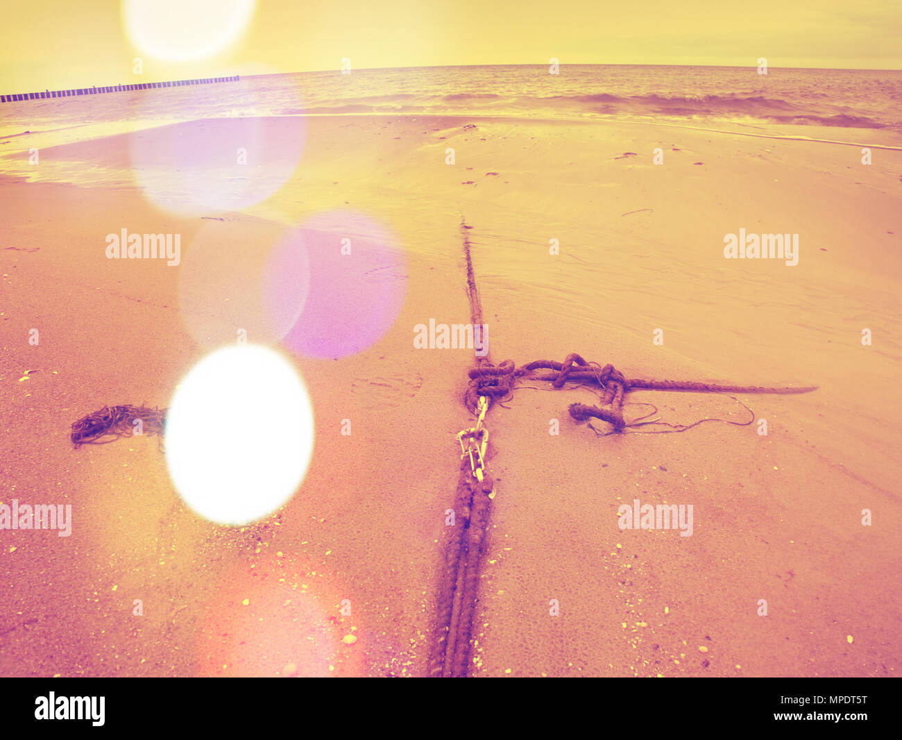 Abstract effect. Ship old anchor rope with snap hook and line under sea ...