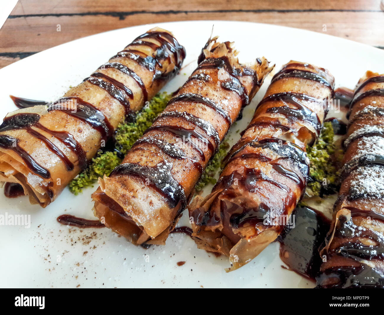 Crispy crepe with tahini and chocolate sauce at restaurant. Dessert ...