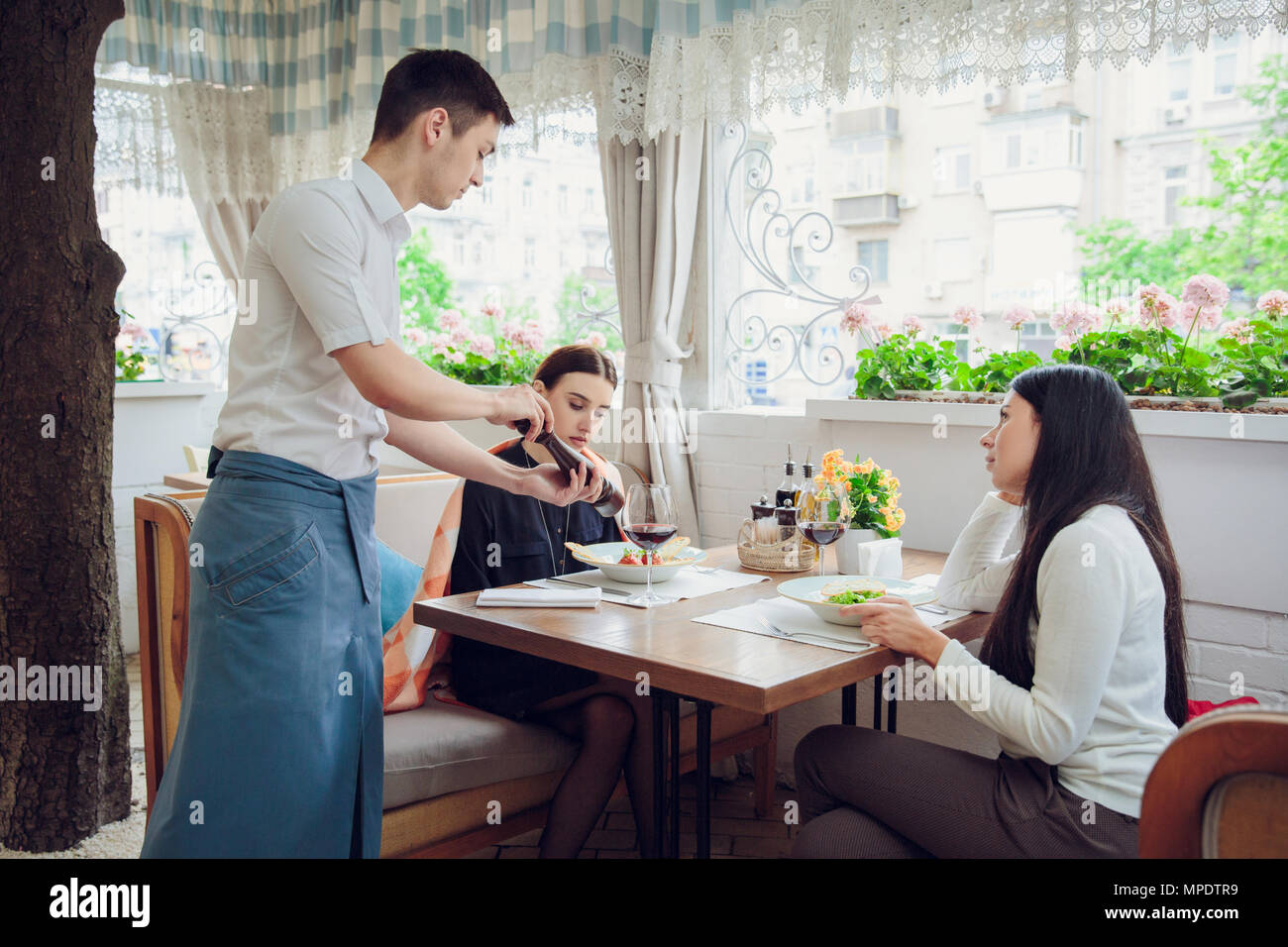 Nice talk. cook telling a female guests about the dish he is serving ...