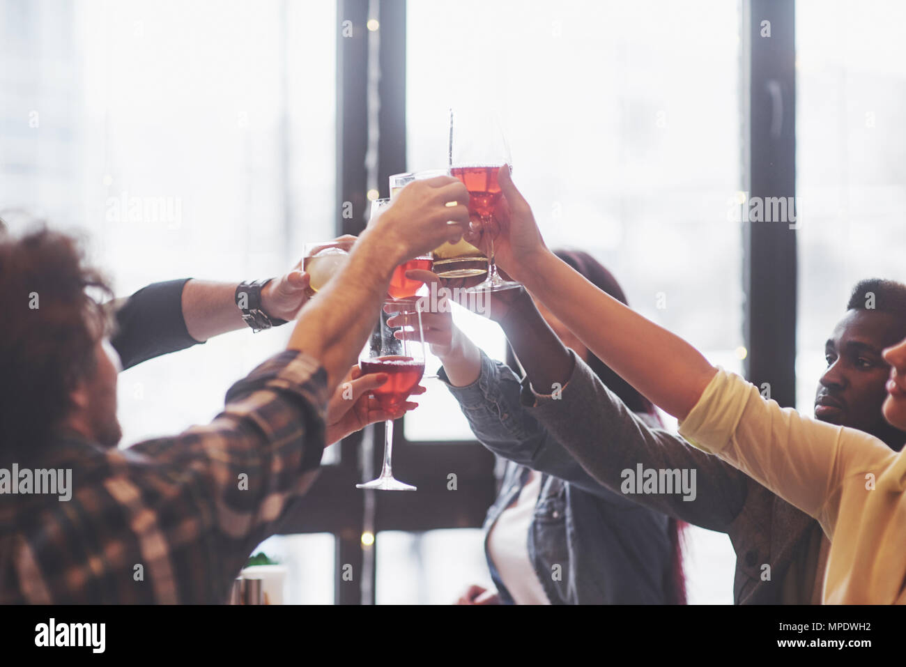 Hands of people with glasses of whiskey or wine, celebrating and ...