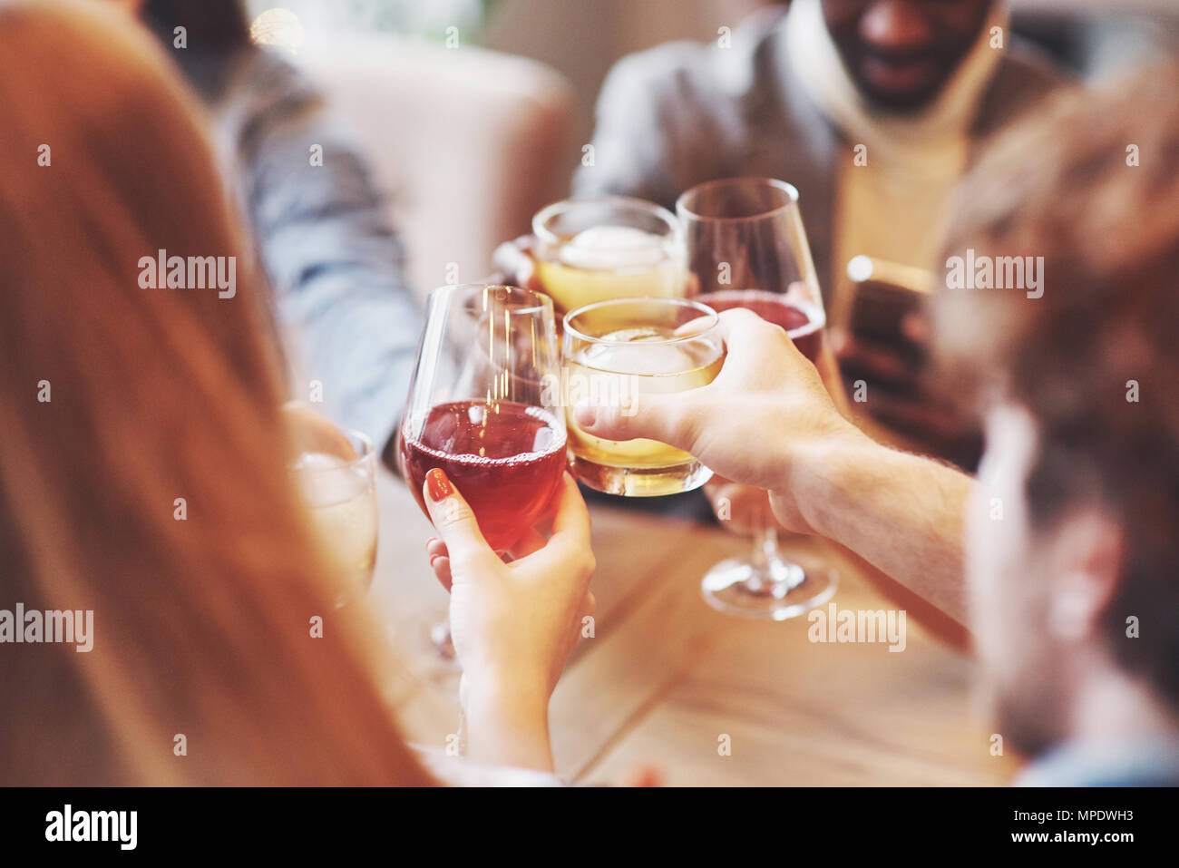 Hands of people with glasses of whiskey or wine, celebrating and ...