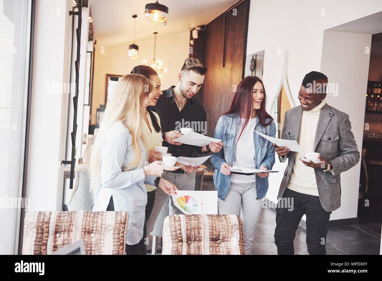 Successful business people are using gadgets, talking and smiling ...