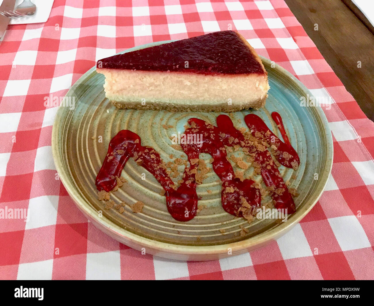 Raspberry Cheesecake served at Restaurant on Red Tablecloth. Ready to ...