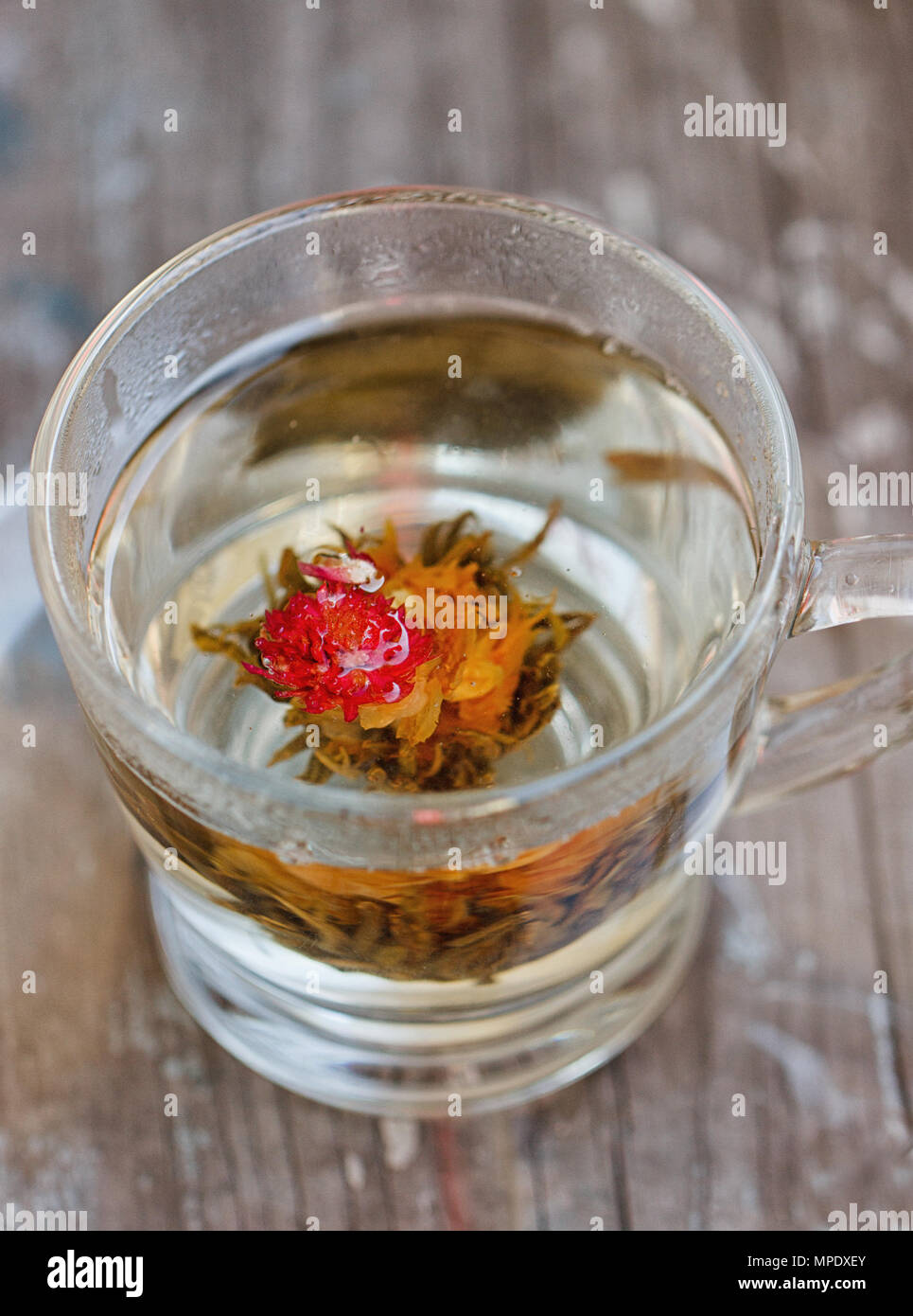 exotic green tea with flowers in glass cup Stock Photo - Alamy