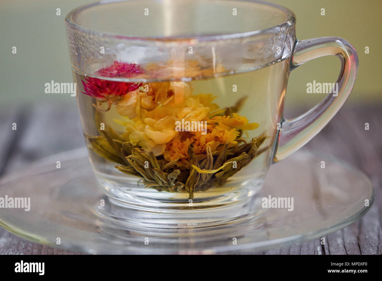 exotic green tea with flowers in glass cup Stock Photo - Alamy