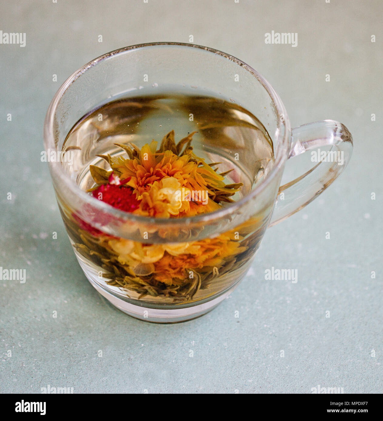 exotic green tea with flowers in glass cup Stock Photo - Alamy
